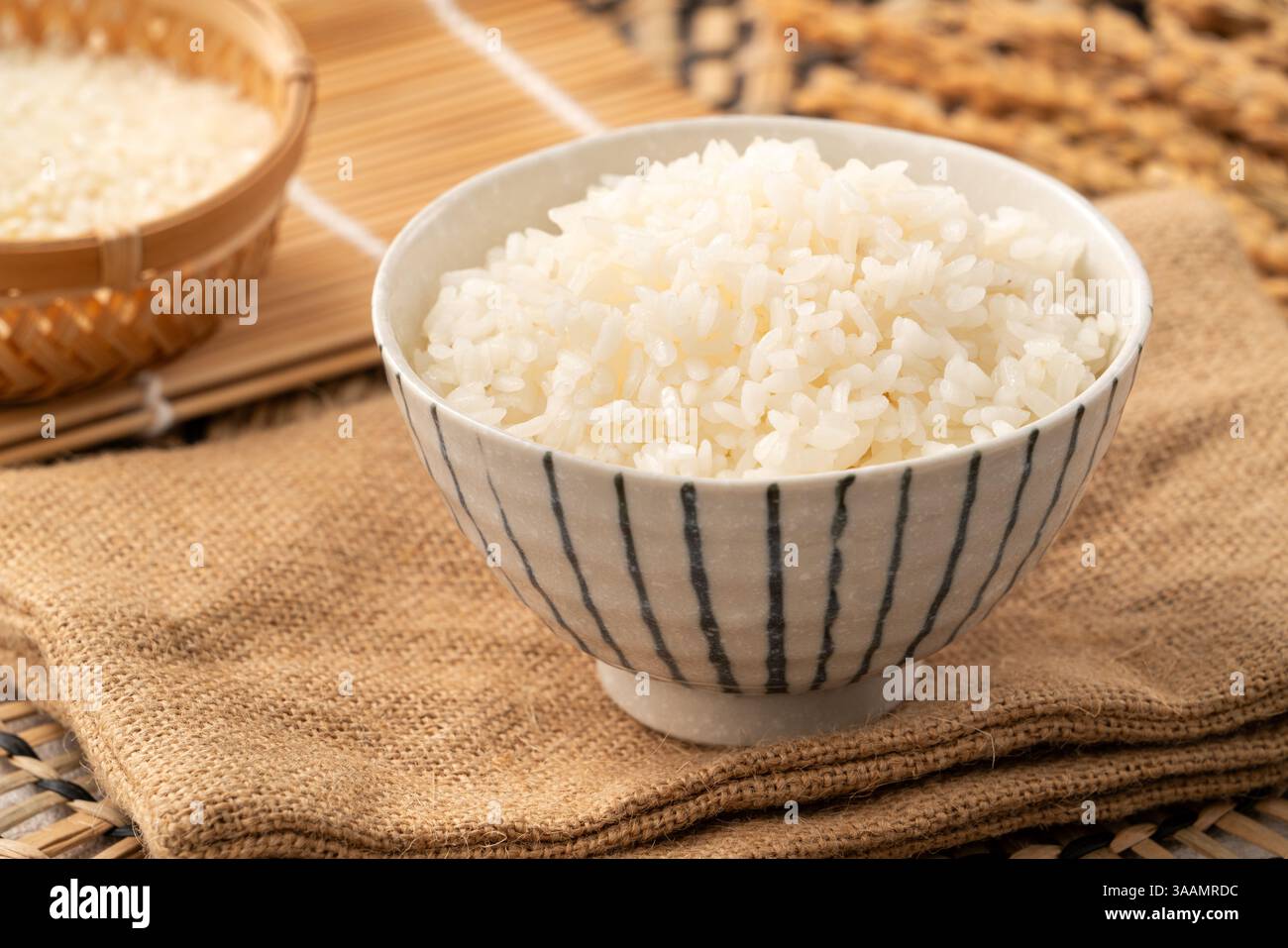A bowl of freshly cookd steamed white rice, soft, fluffy, and slightly ...