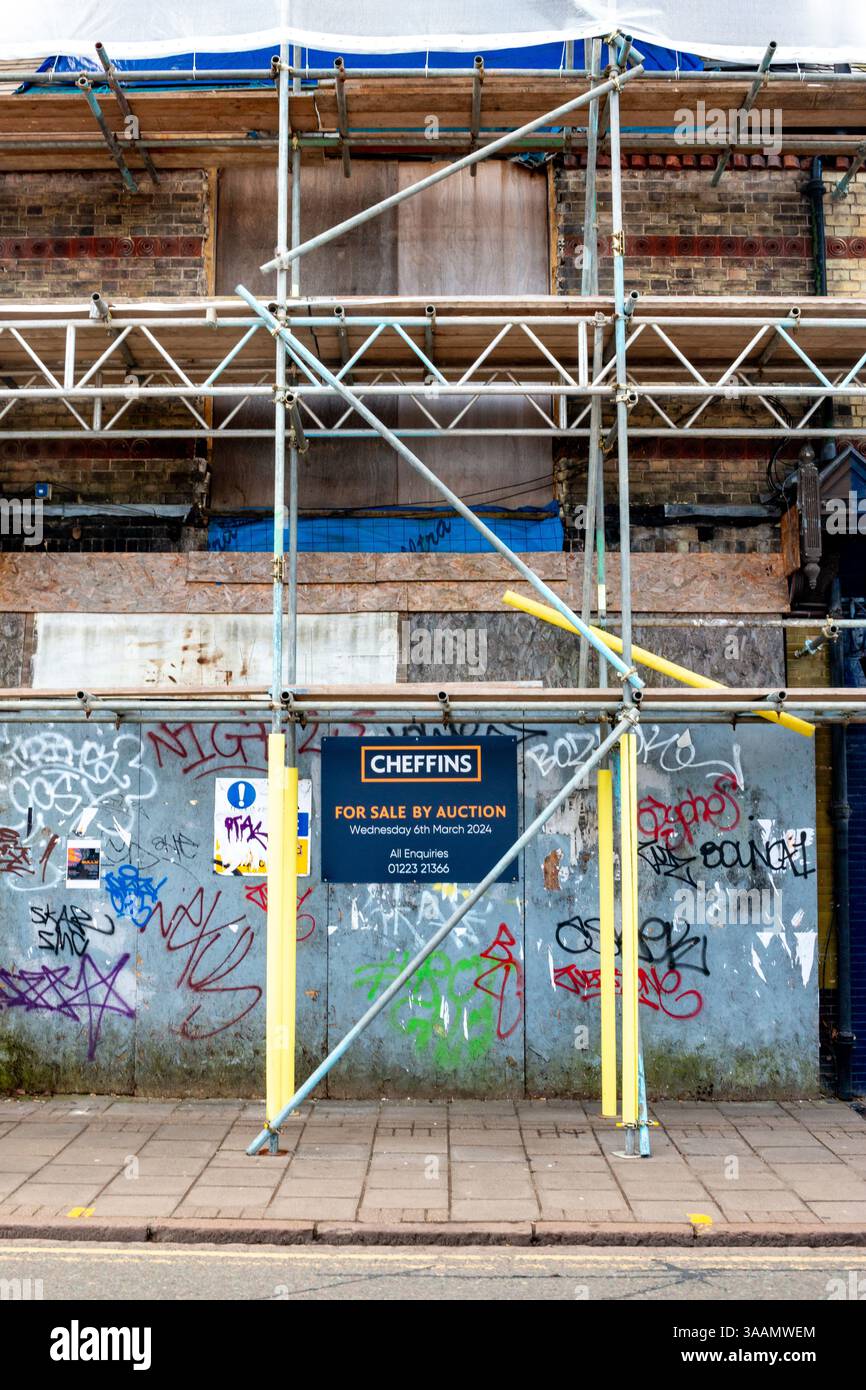 The burnt shell of Mr Gee's electrical shop covered in scaffolding and ...