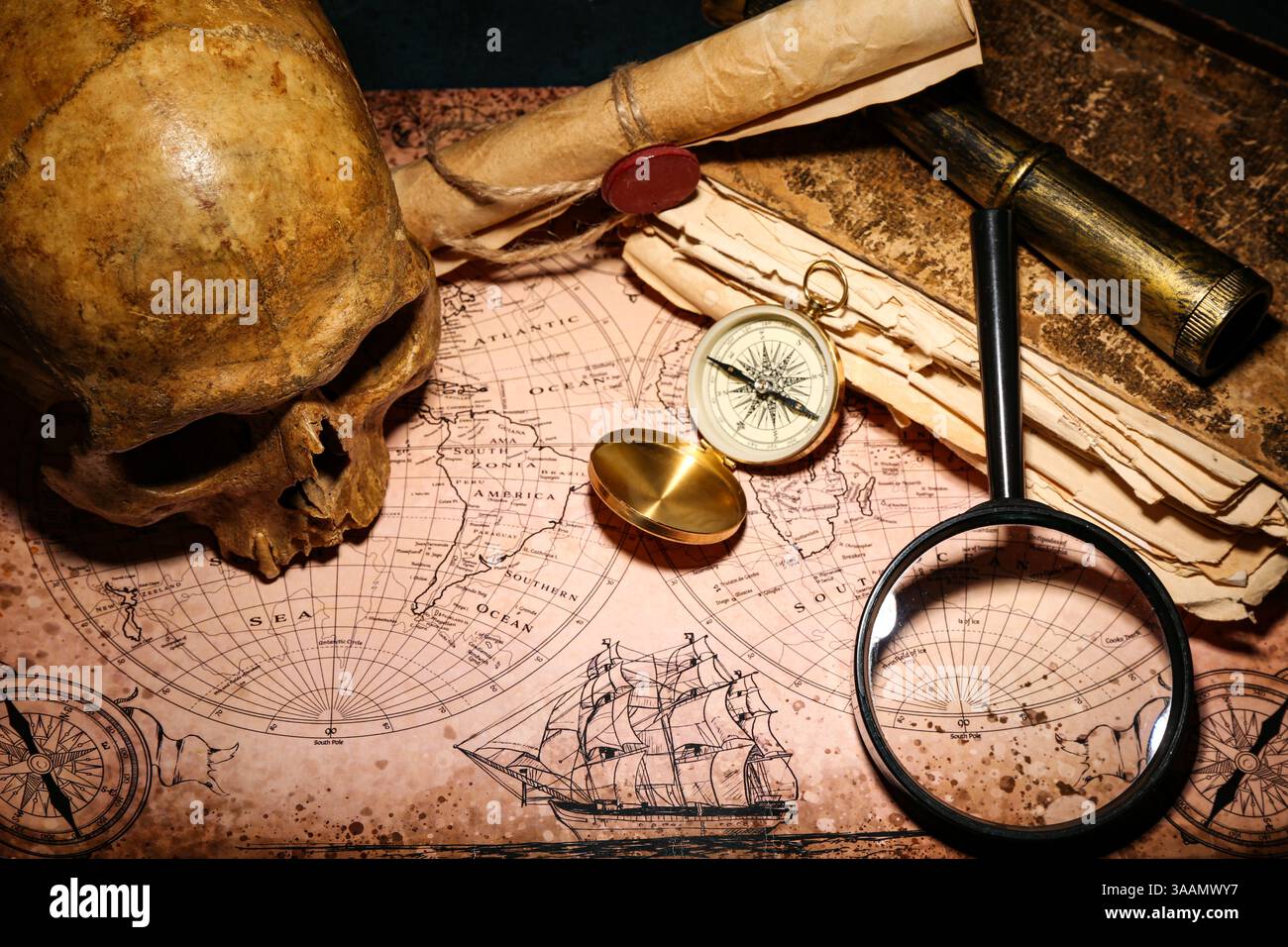 Human skull with old manuscripts, travel equipment and world map on ...