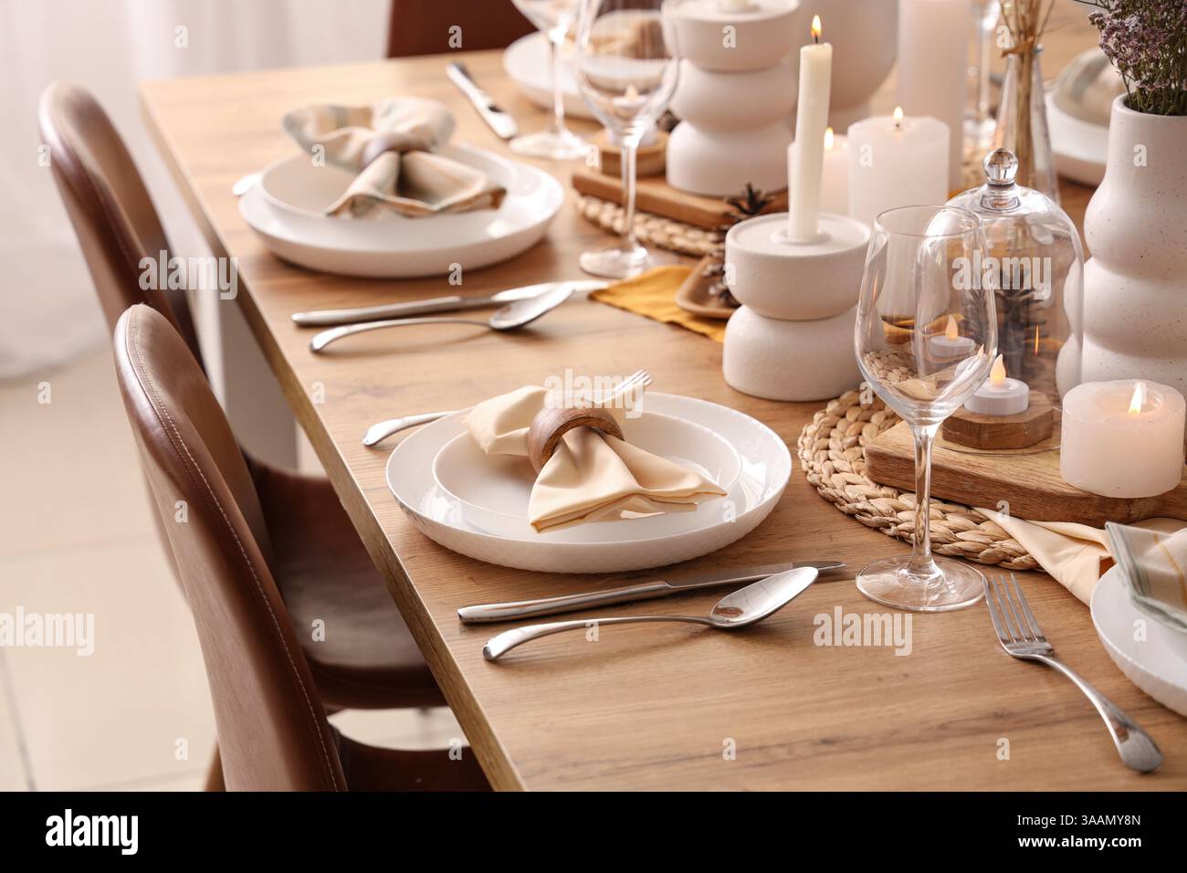 Elegant table setting with folded napkins, cutlery and plates Stock ...