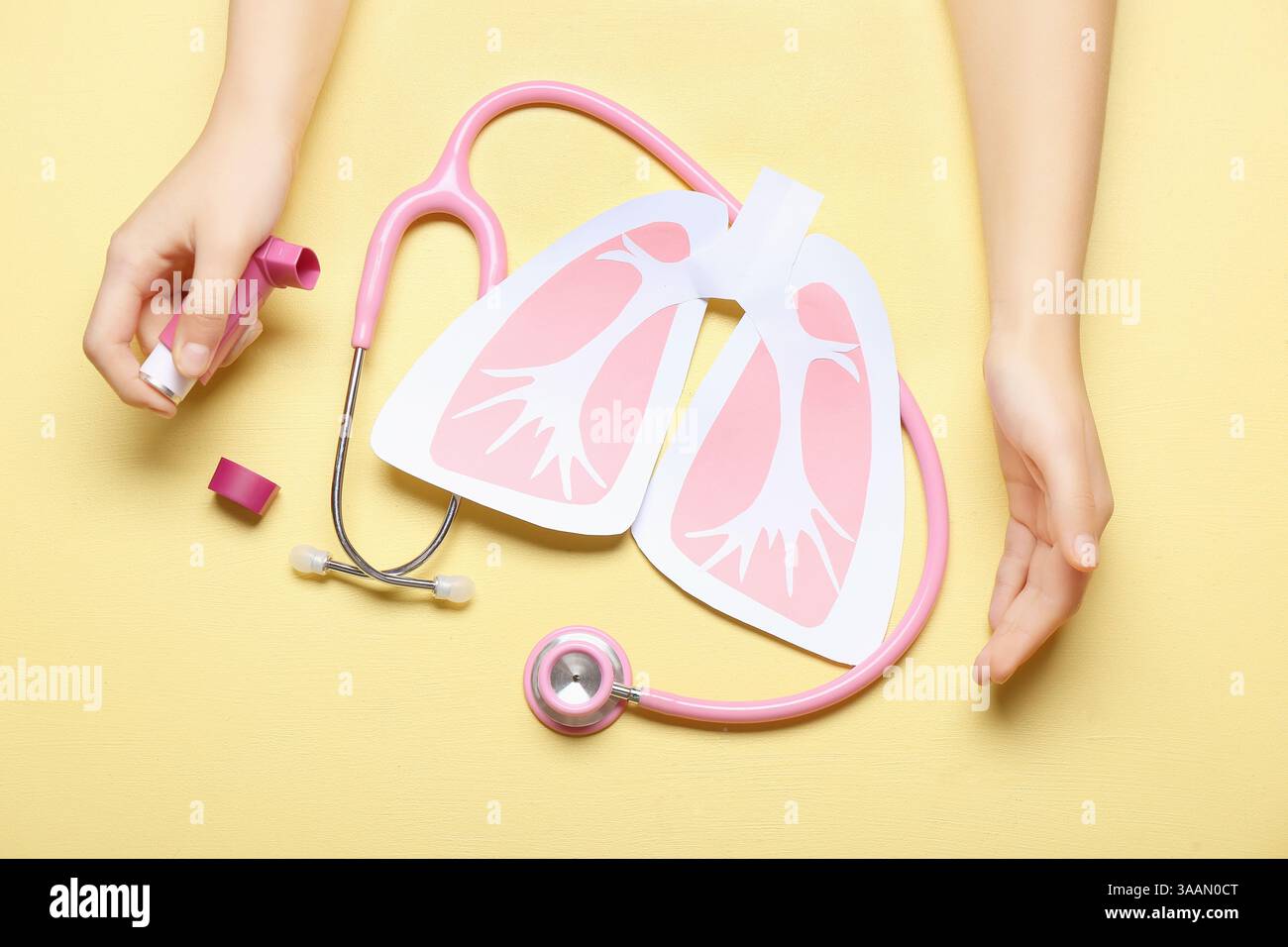 Female hands with asthma inhaler, paper lungs and stethoscope on yellow ...