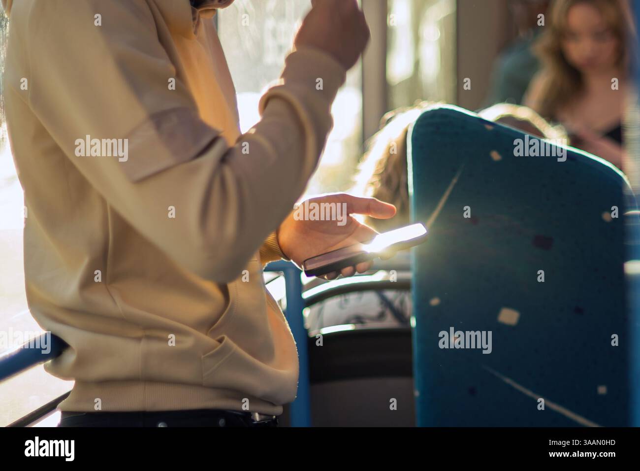 man using a smart phone in a public transport Stock Photo - Alamy