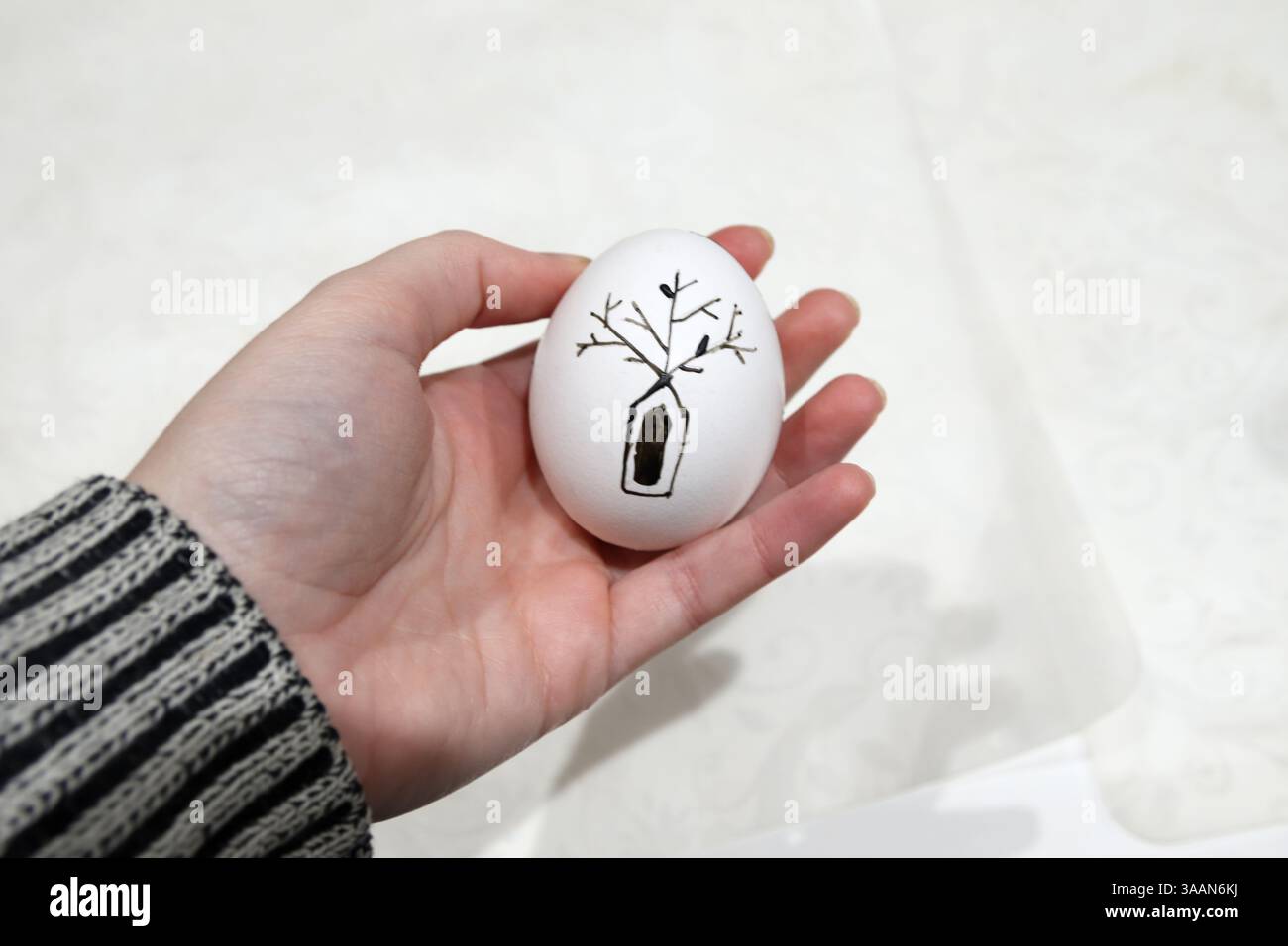 A hand holding a traditional Ukrainian pysanka egg decorated Easter ...