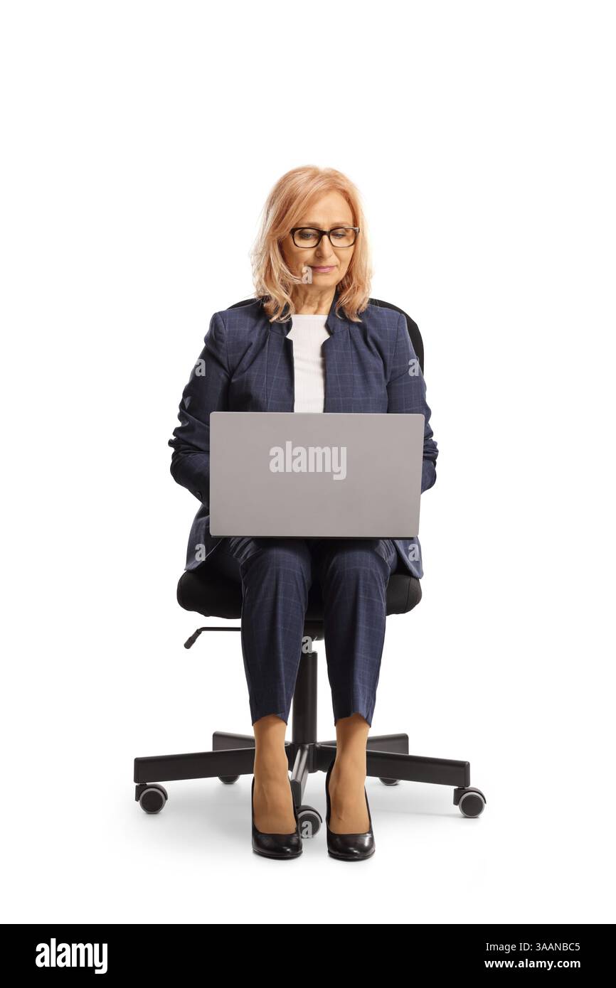 Professional woman sitting in an office chair and using a laptop ...