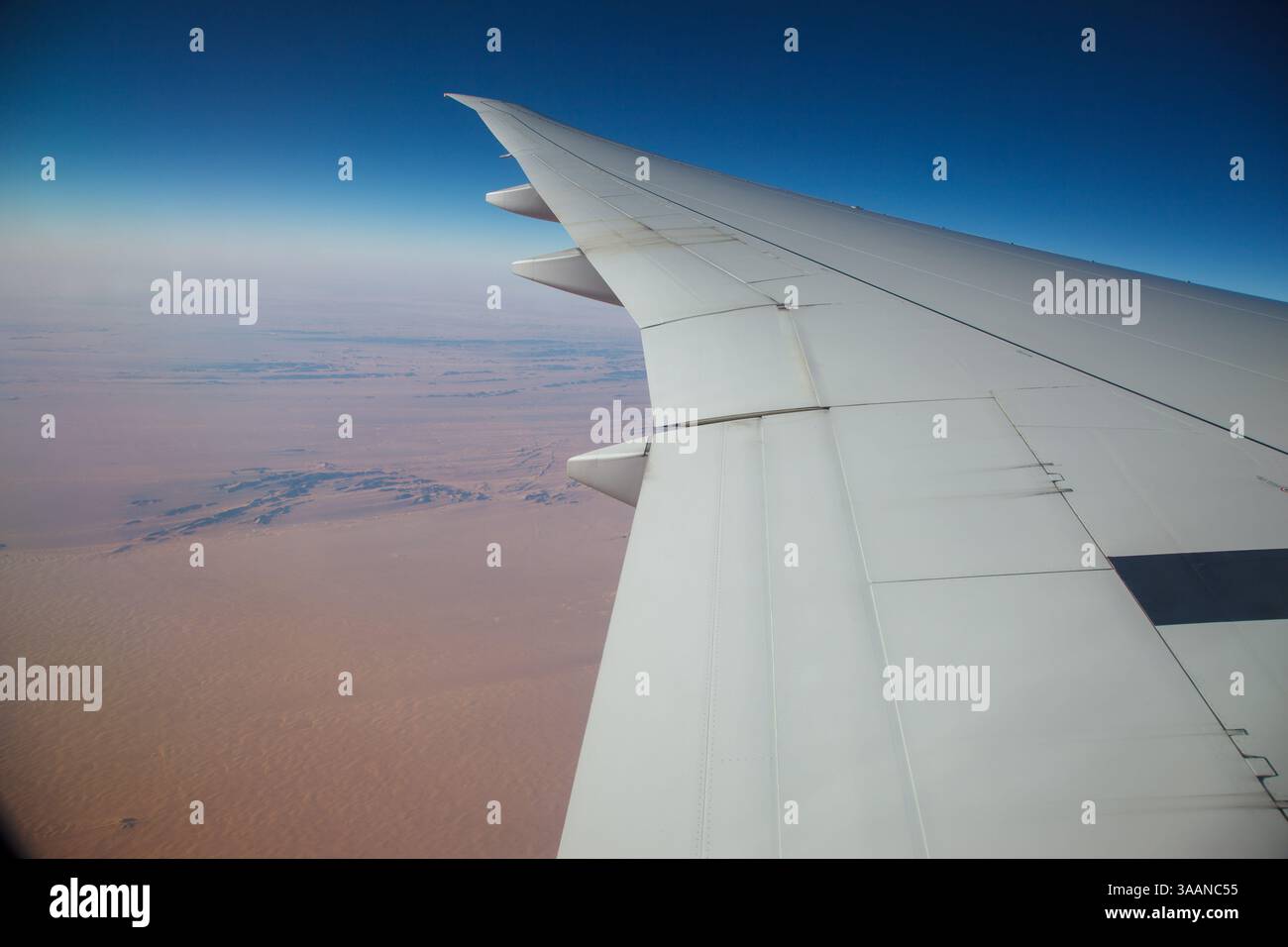 An Airplane view of the wing over the Arabian desert in the United Arab ...