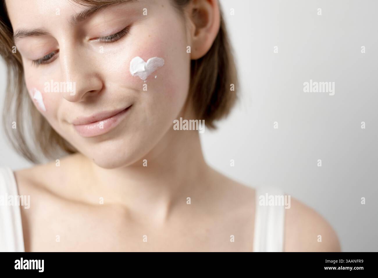 Woman smiling with facial cream applied Stock Photo - Alamy