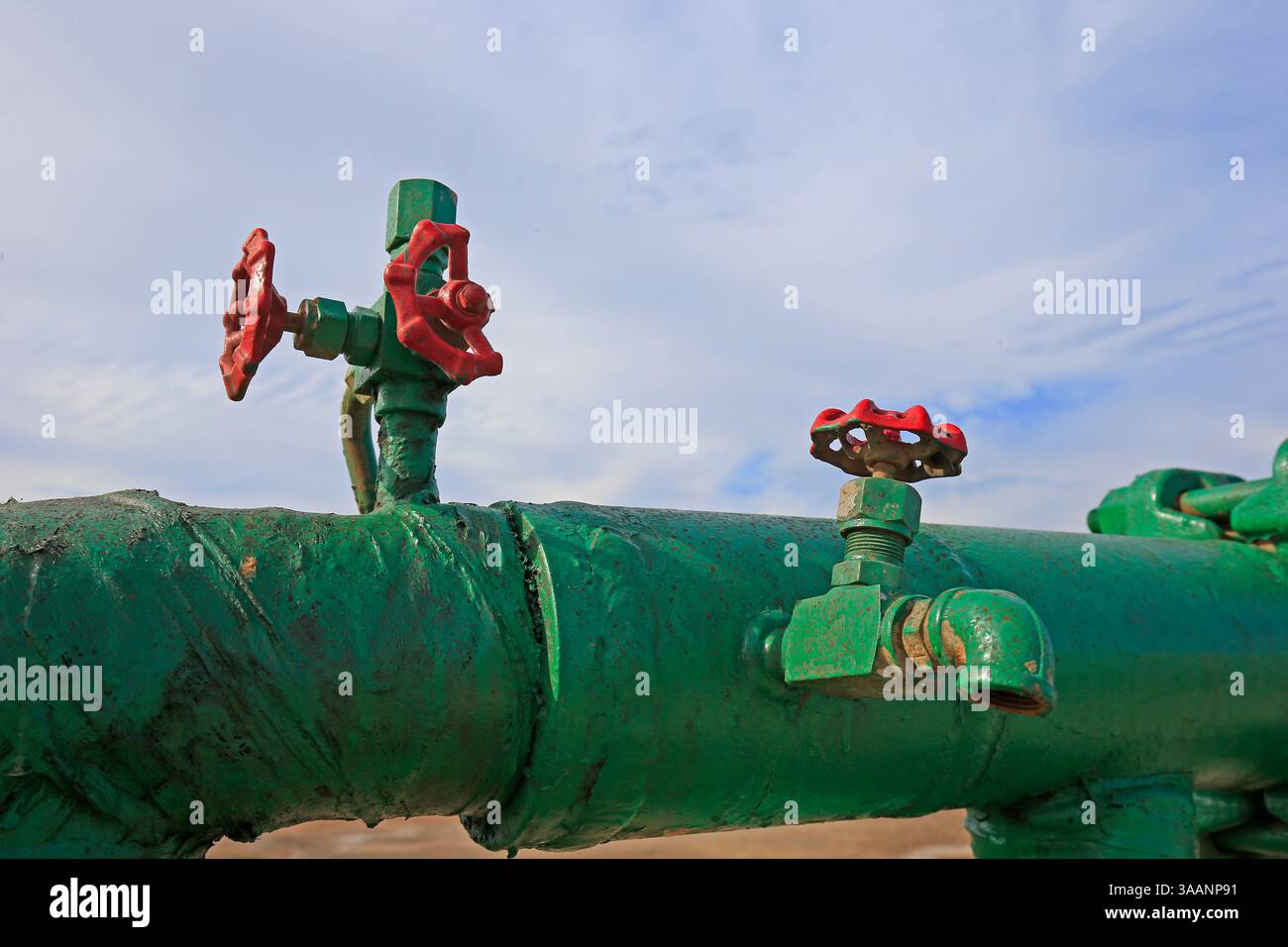 Oil pipes and valves Stock Photo - Alamy