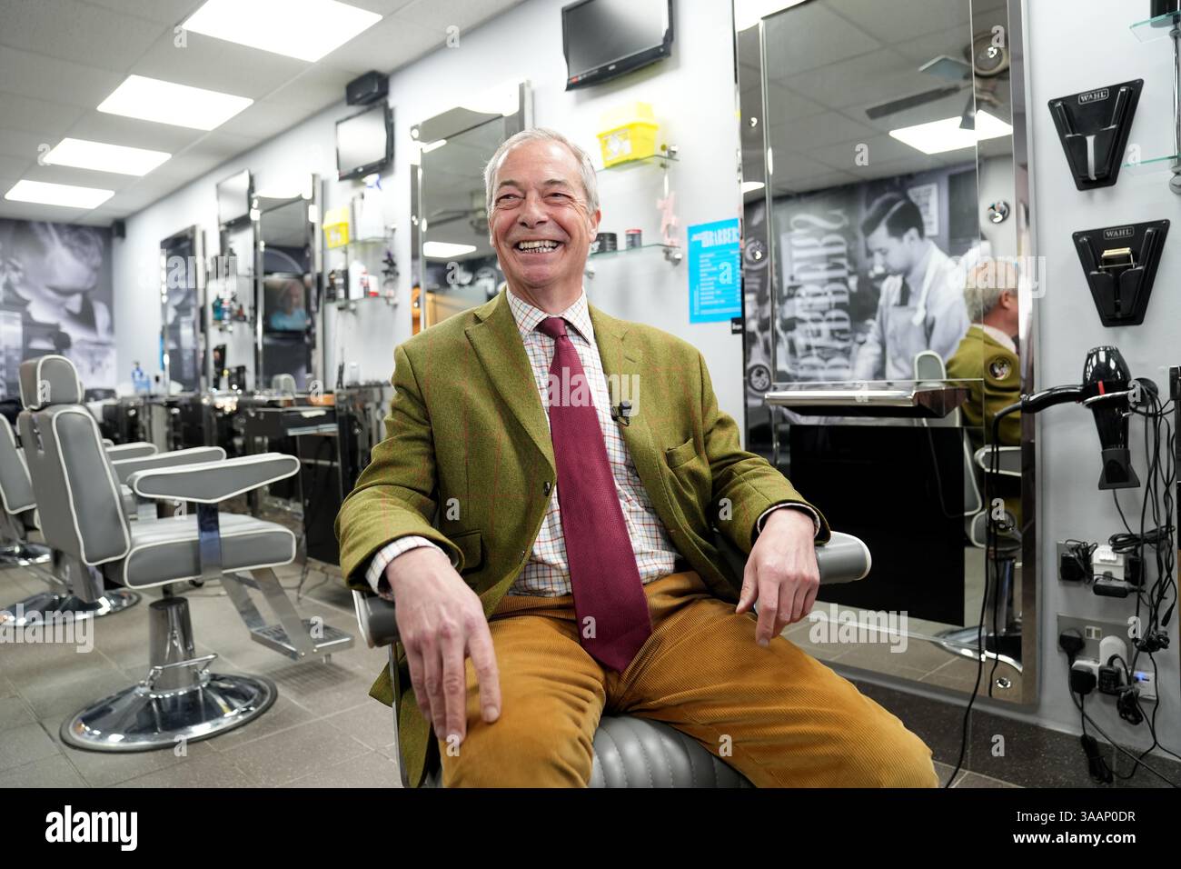 Reform UK leader Nigel Farage visits a barber's shop, during Reform UK ...