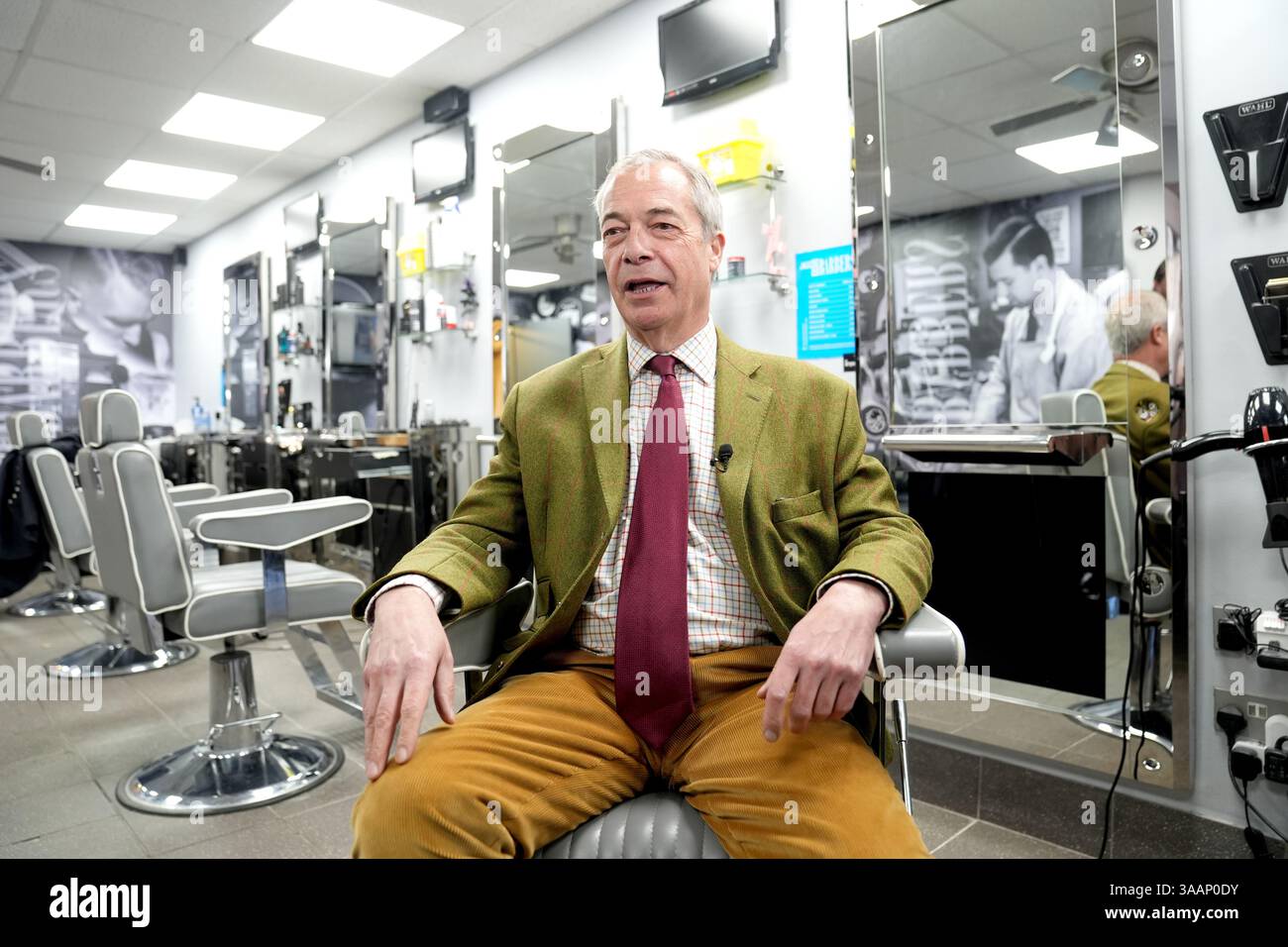 Reform UK leader Nigel Farage visits a barber's shop, during Reform UK ...