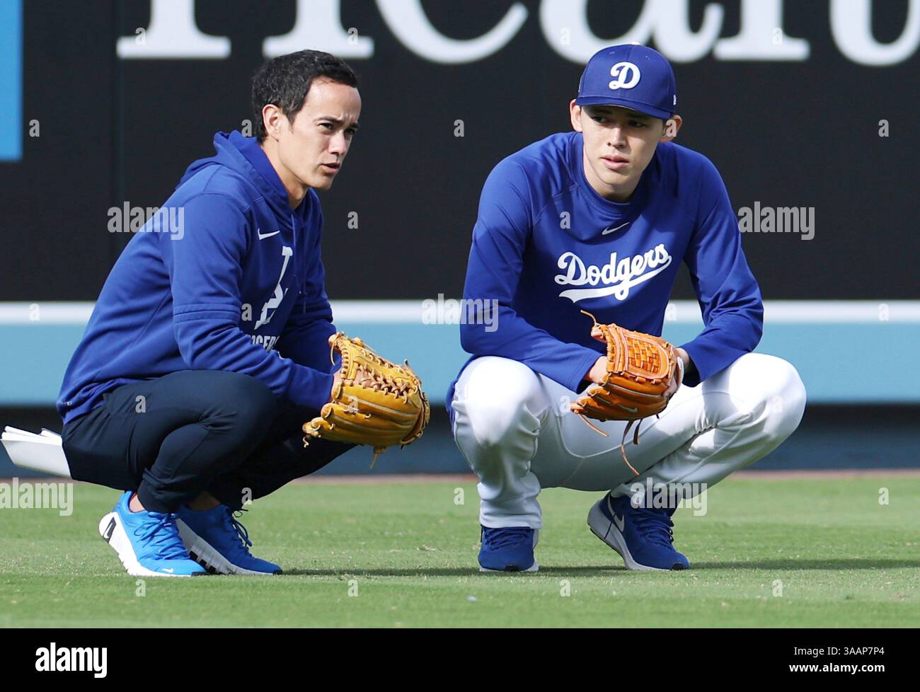 Los Angeles Dodgers pitcher Roki Suzuki (R) prepares for the next game ...