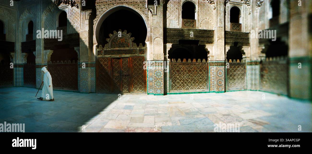 Panoramic view of a muslim man walking in the medersa, Medersa Bou ...