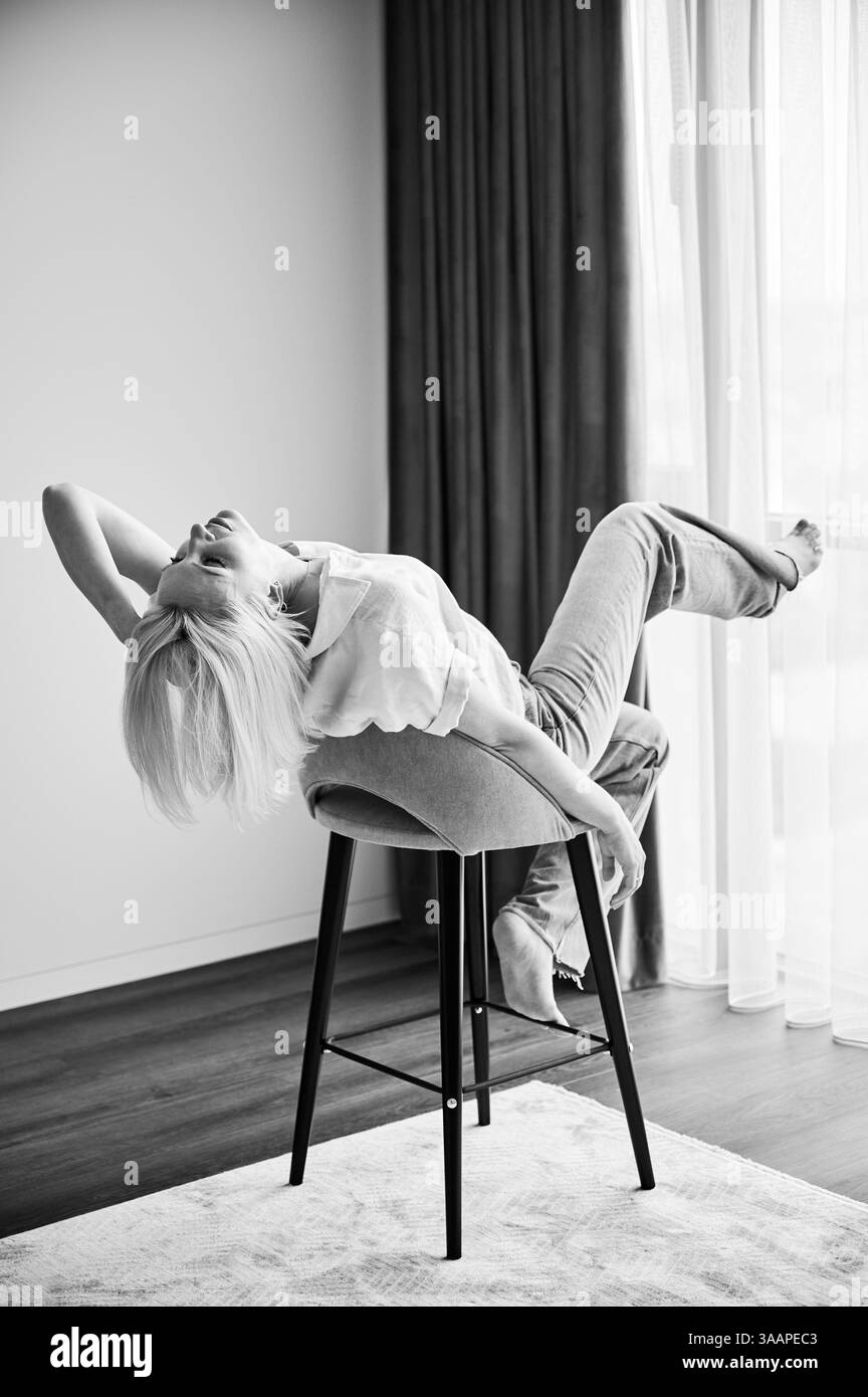 Full length photo of pretty woman sitting on bar stool. Female raising ...