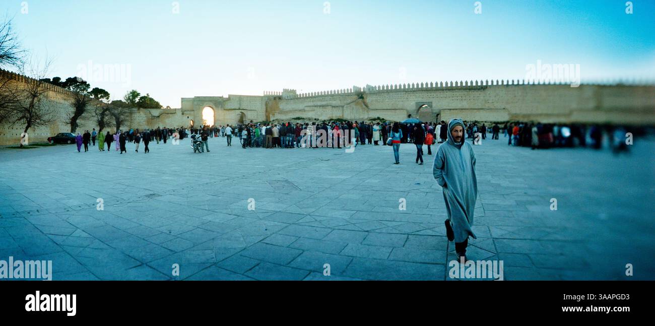 Panoramic view of a muslim man walking through a courtyard in medina in ...