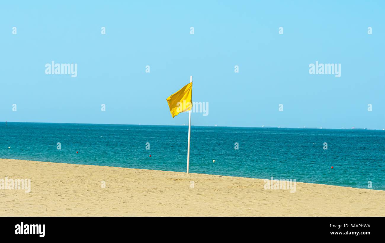 Yellow flag on the beach in summer summer, lifeguards sign to bathe ...