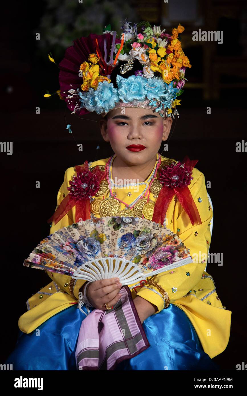 A young ethnic Shan boy dressed in colorful costumes poses for a photo ...