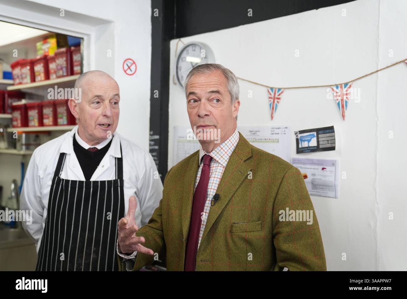 Reform UK leader Nigel Farage visits a butcher's shop during Reform UK ...
