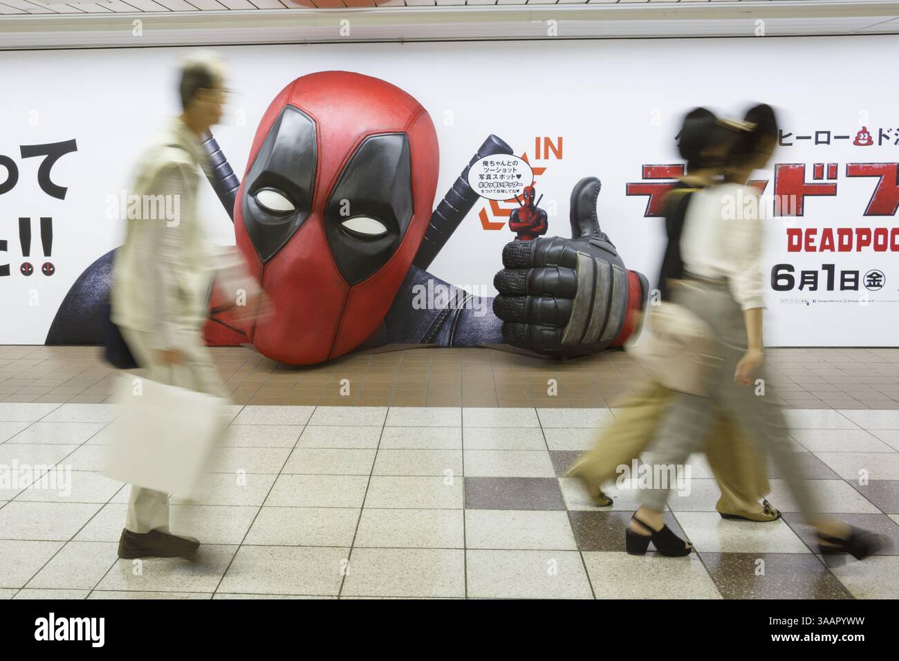 May 30, 2018 - Tokyo, Japan - Pedestrians walk past a big Deadpool head ...