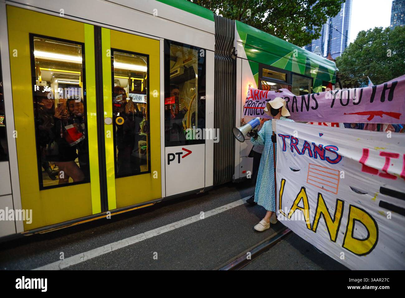 Protesters march on the streets holding banners during the rally. The ...