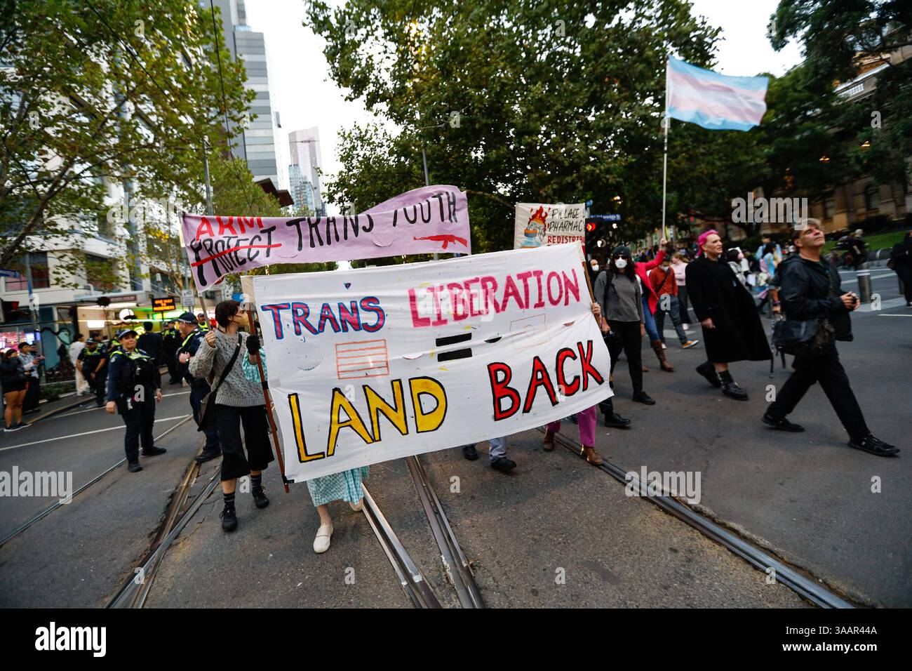 Protesters march on the streets holding banners during the rally. The ...