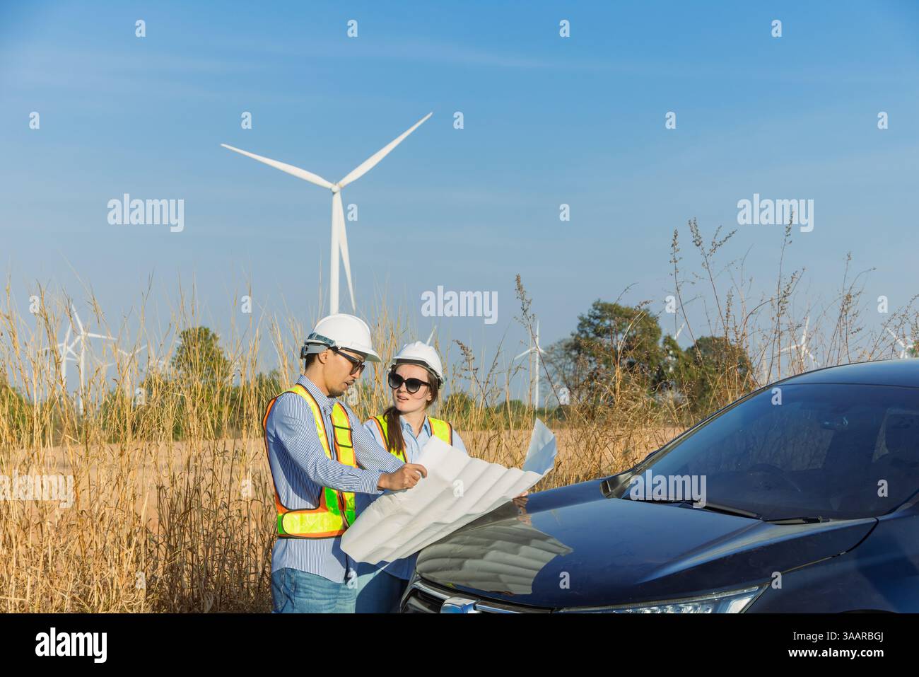 Professional engineer workers teamwork site survey at wind turbine farm ...