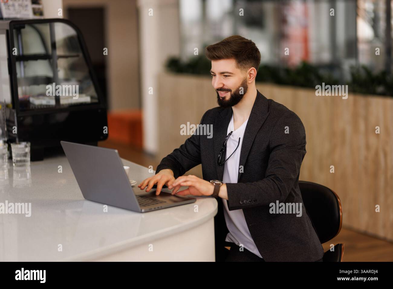 Happy male entrepreneur typing on pc keyboard, checking email, taking ...