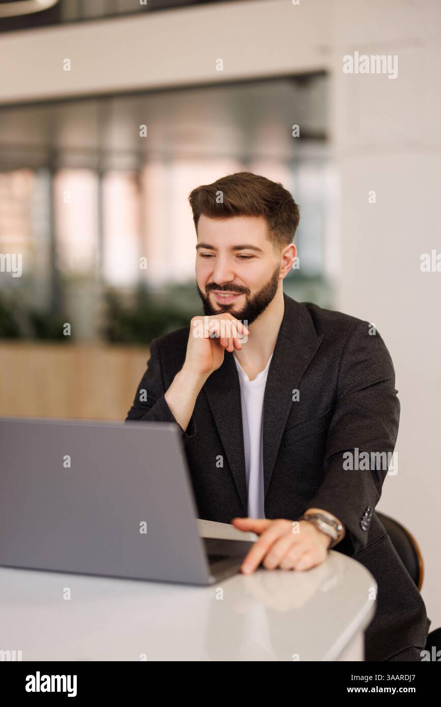 Happy male entrepreneur typing on pc keyboard, checking email, taking ...