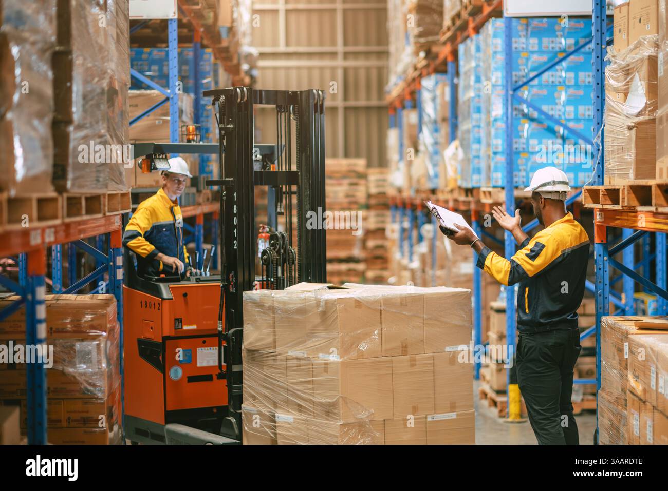 Warehouse worker male working duty stock control with forklift truck ...