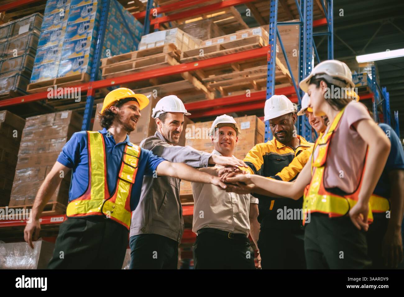 Group of worker in warehouse team join hands together in inventory ...