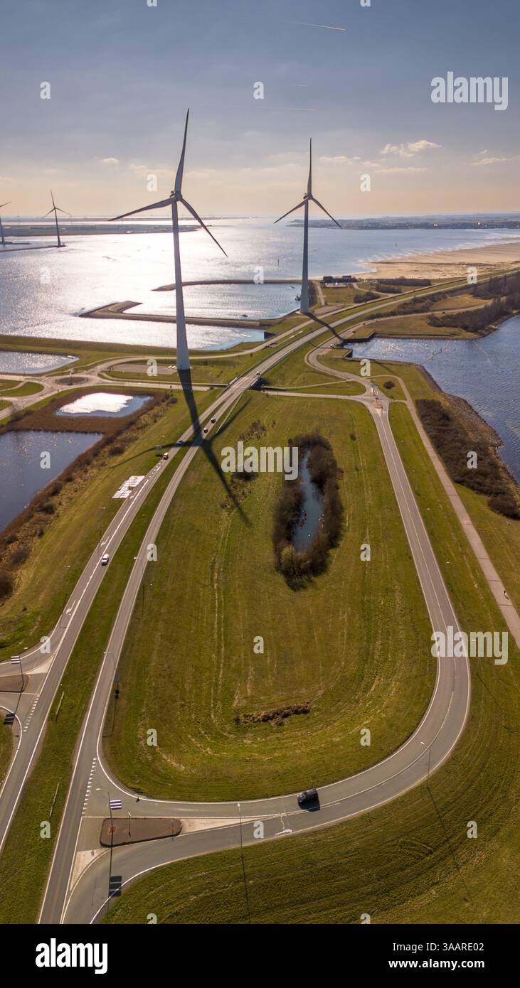 A scenic aerial view of a coastal wind farm with multiple wind turbines ...