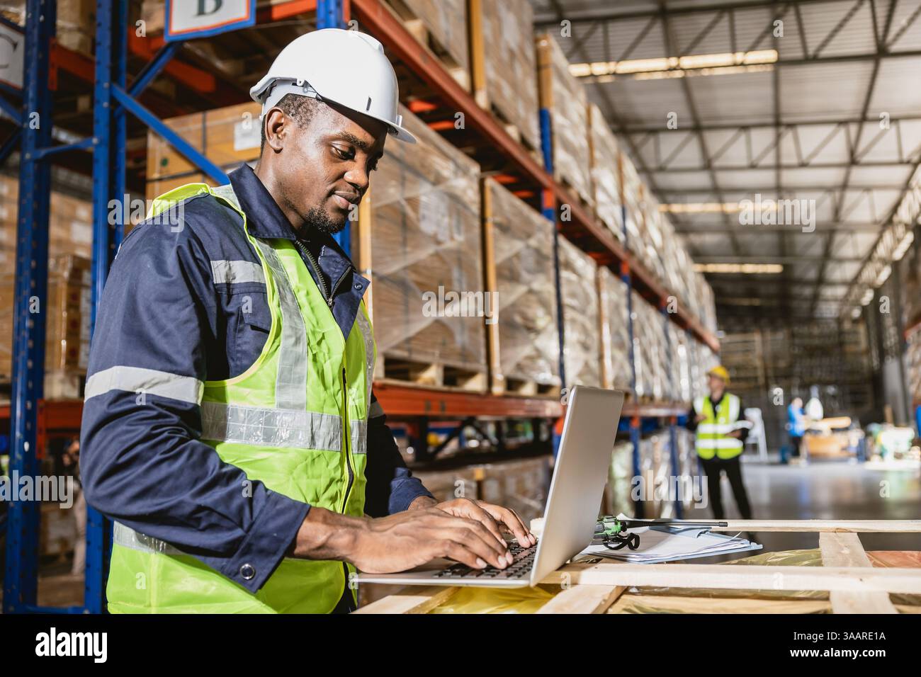 african black professional warehouse worker using digital modern device ...
