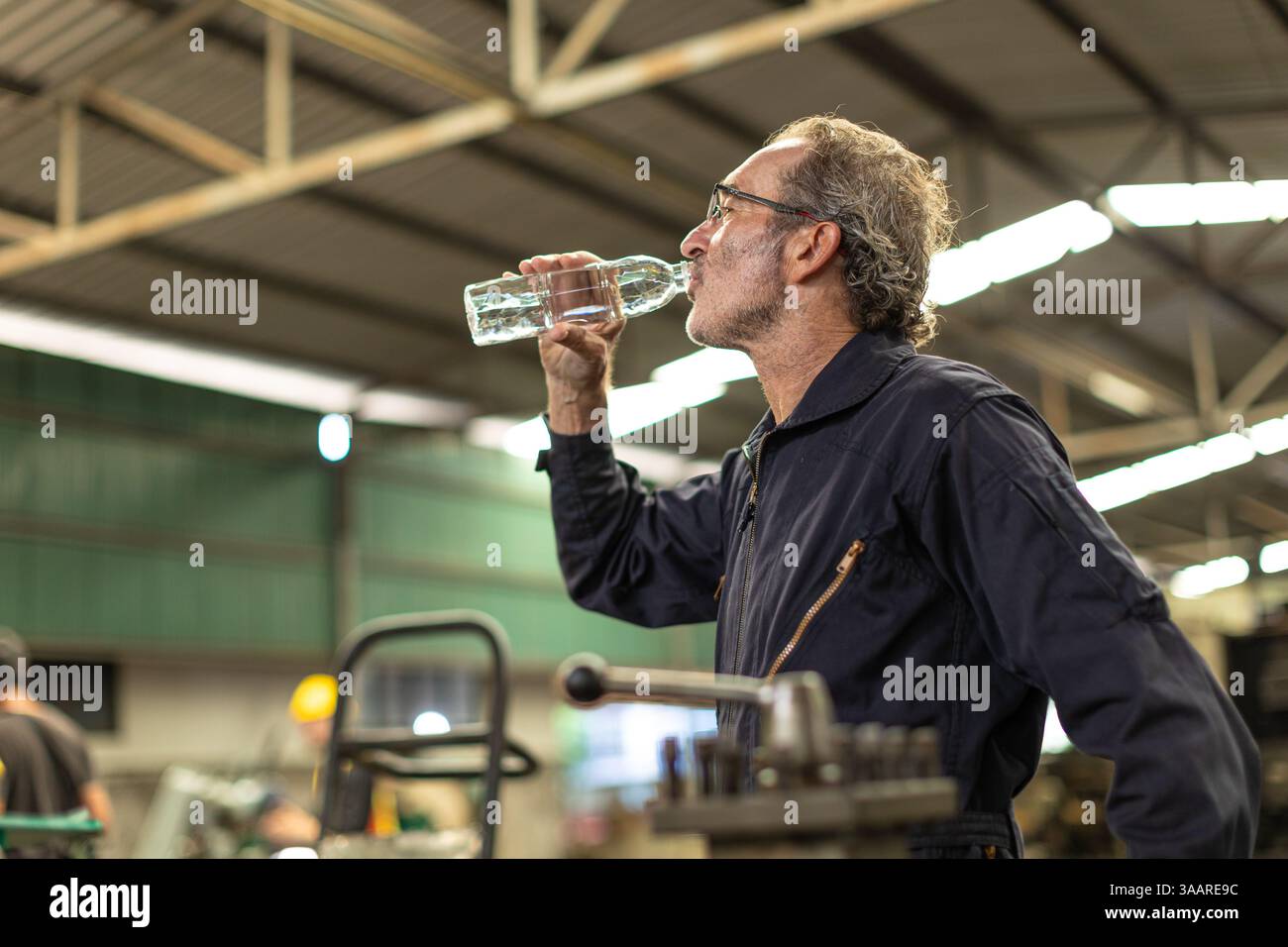 Senior worker thirsty tired exhausted refresh drinking clean water from bottle brake relax ...