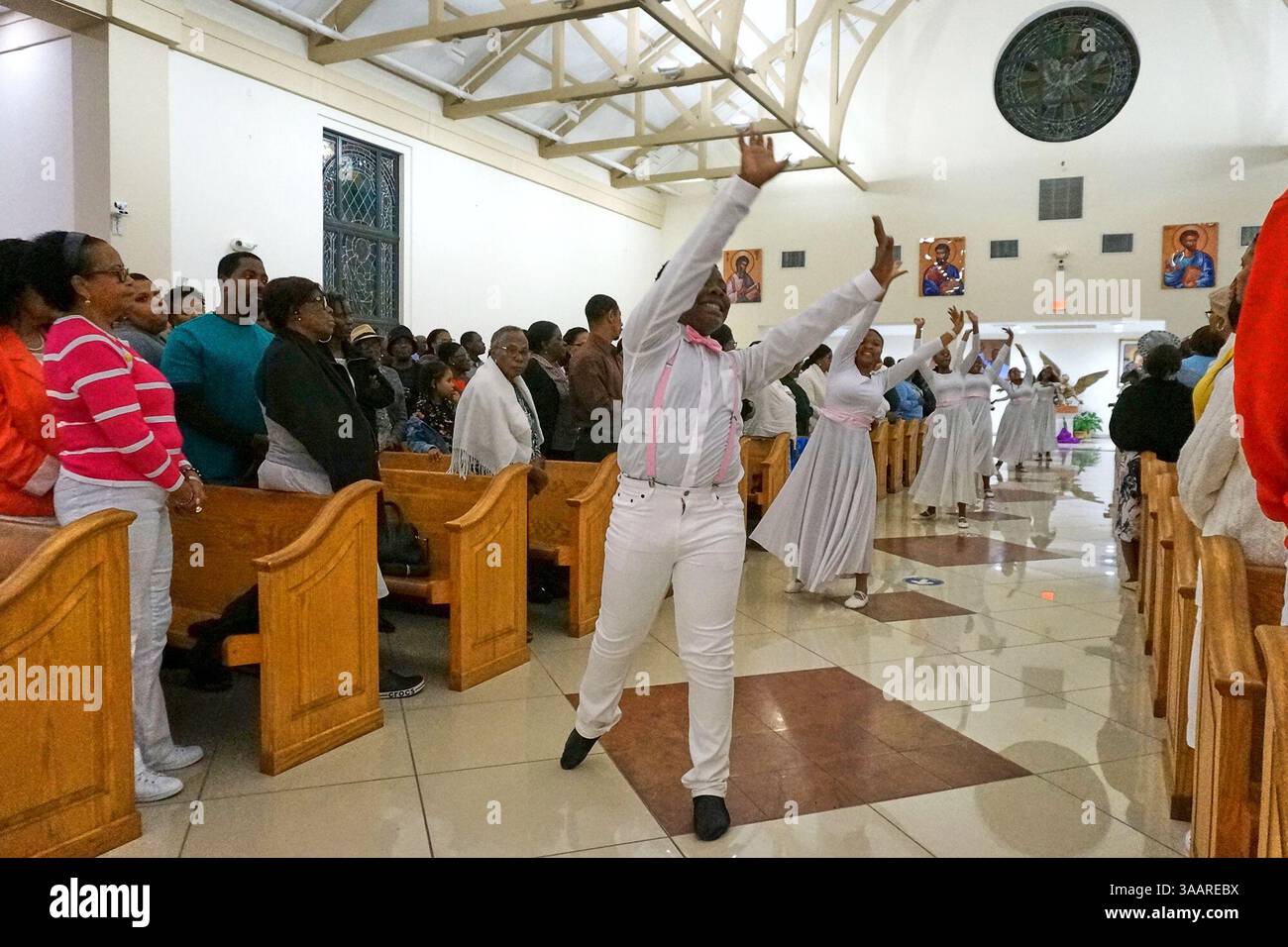 Members of the "mimers" youth group dance as they process before Mass ...