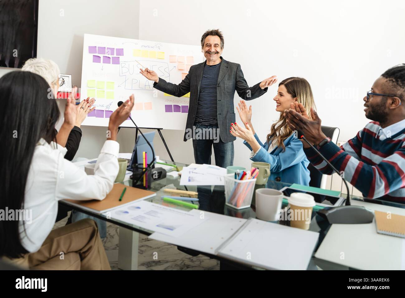 Diverse businesspeople applauding during a successful presentation ...