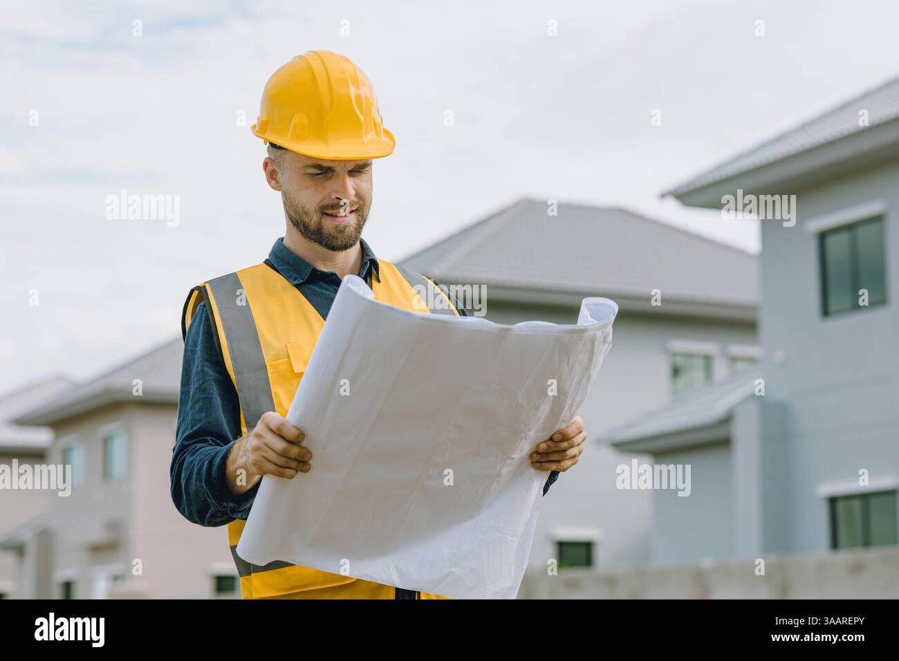 Construction worker happy smile standing with floorplan, Caucasian engineer male standing ...