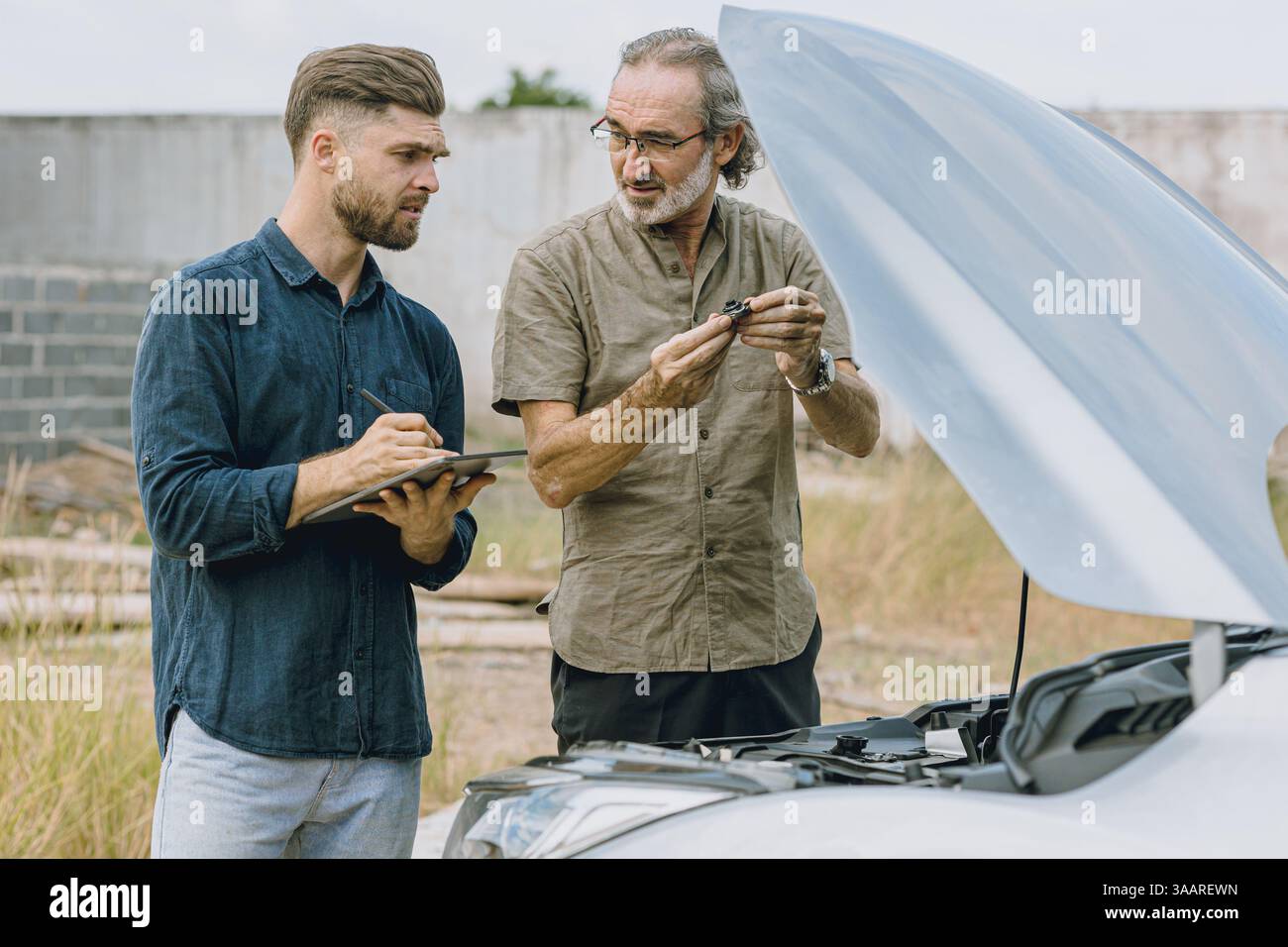 Senior male with car problem broken standing talking discussion with ...
