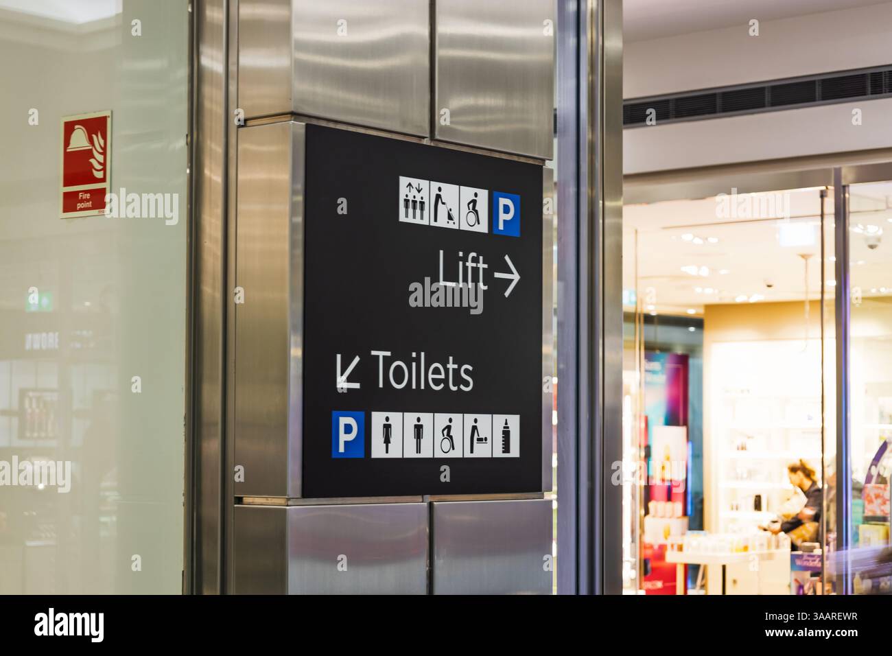 Modern shopping center sign showing directions for lift, restrooms, and ...