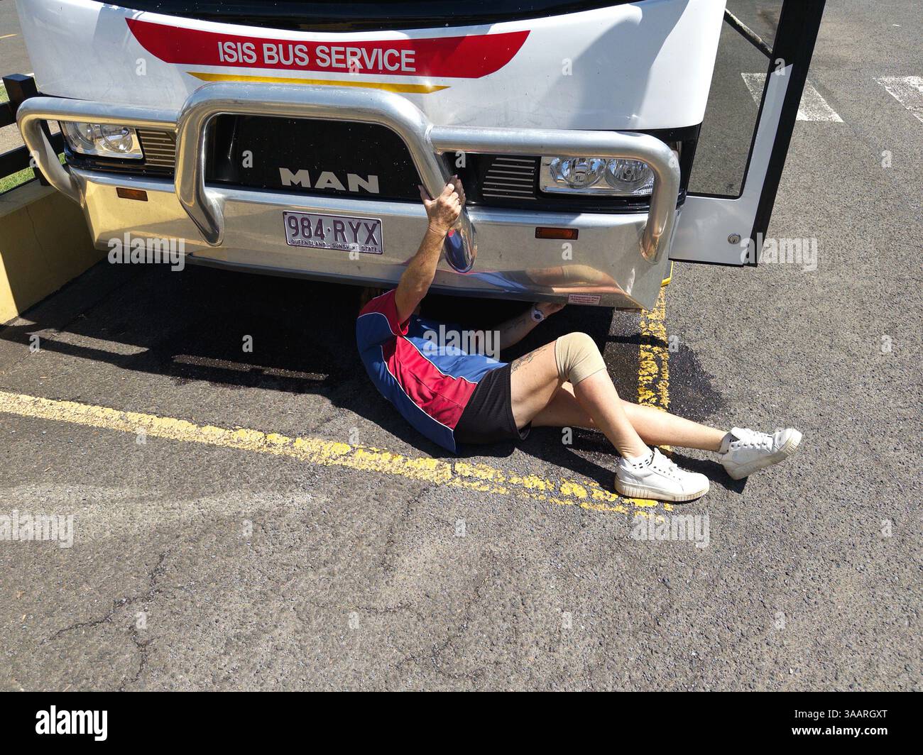 A driver checks under a bus in the car park at Bundaberg Brewed Drinks ...