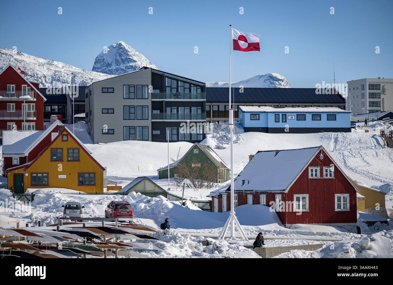 The flag of Greenland in the colony harbor in Nuuk, Greenland at the ...