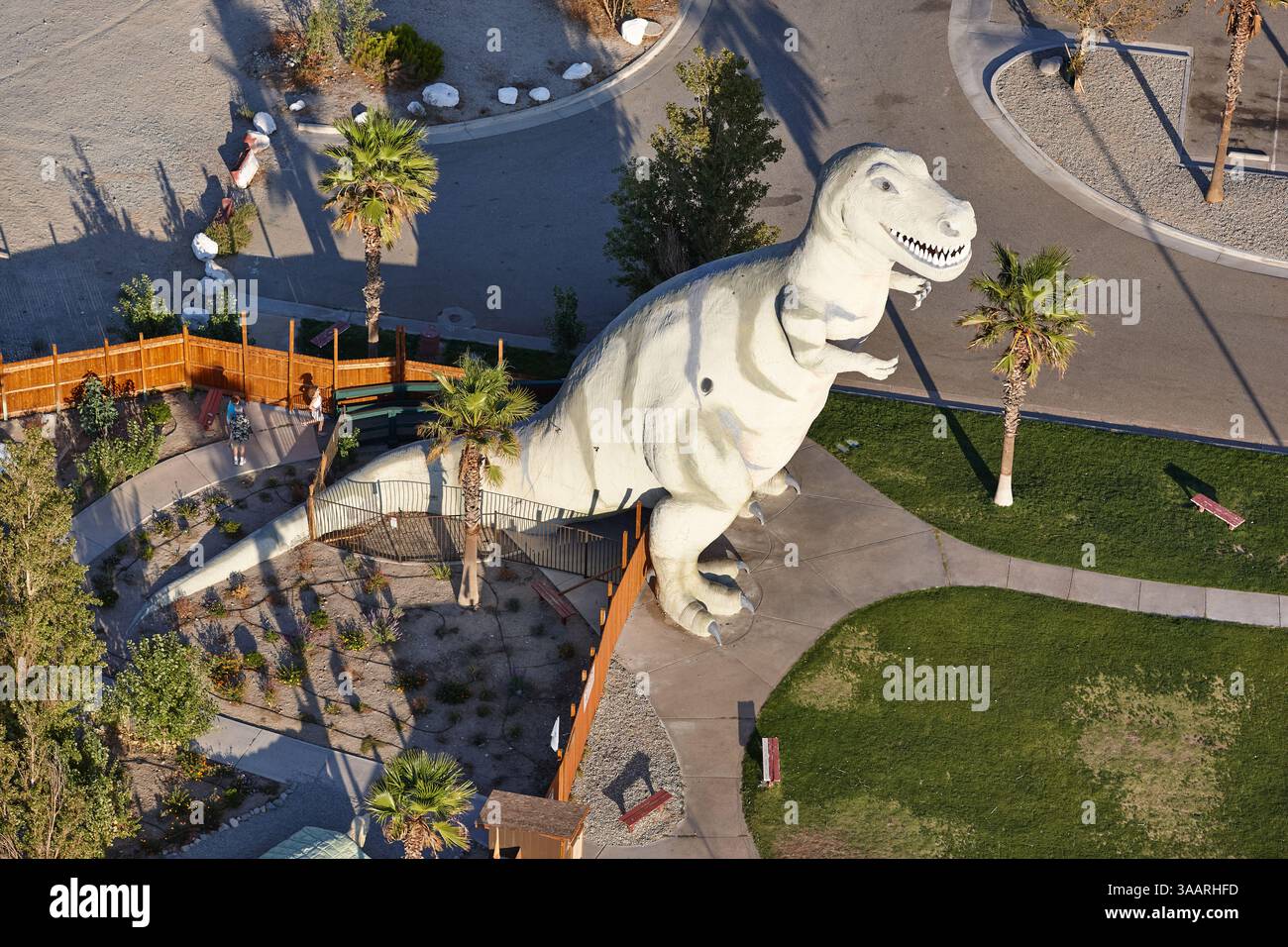 AERIAL VIEW. A monumental tyrannosaur as a roadside attraction ...