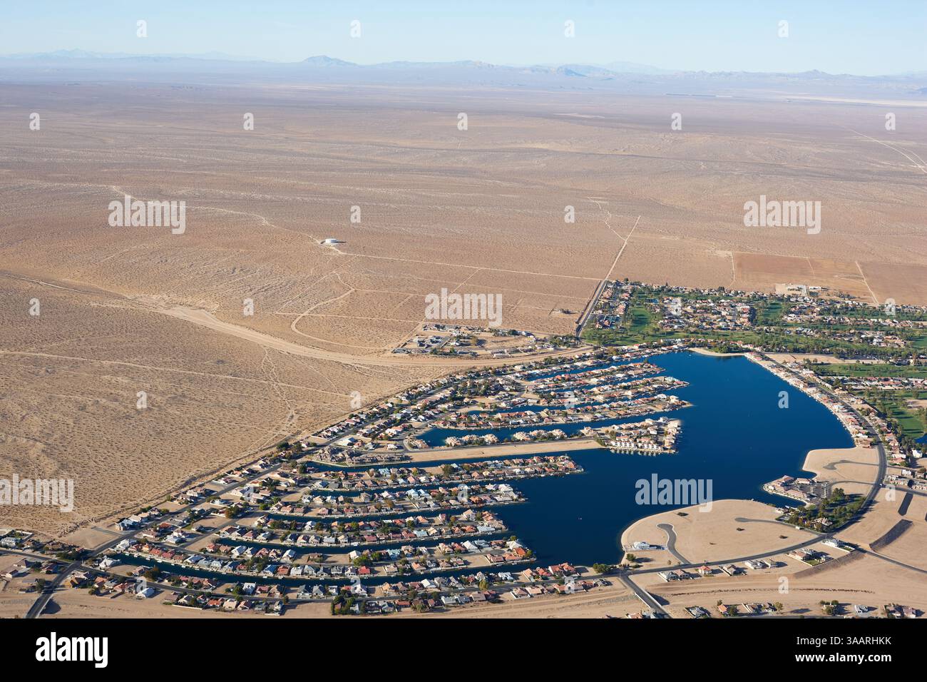 AERIAL VIEW. Housing development and a man-made lake in stark contrast ...