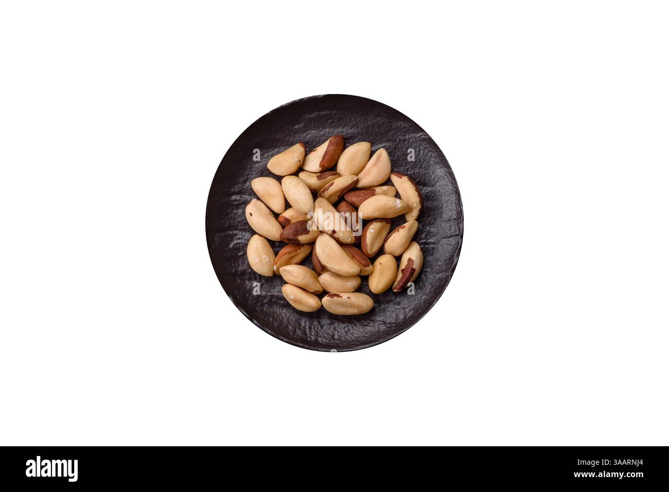 Brazil nut kernels in ceramic bowl on white background Stock Photo - Alamy