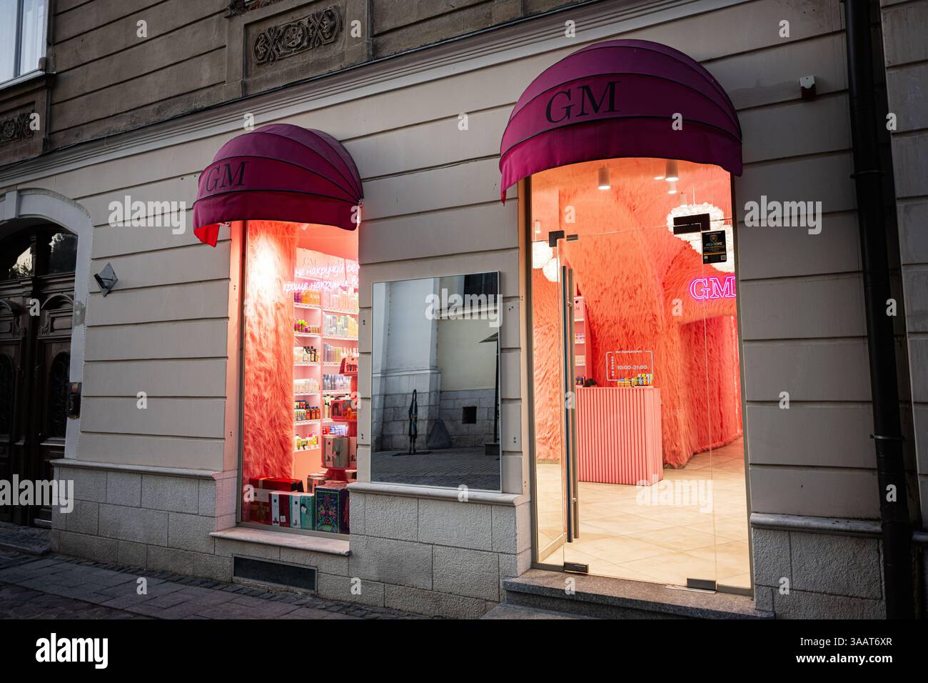 Lviv, Ukraine - March 31, 2025: Illuminated storefront GM with pink ...