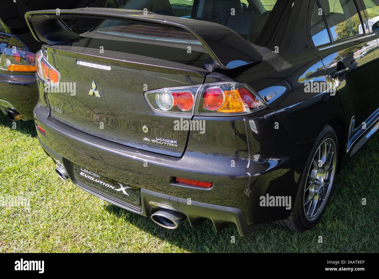 Rear view of a black mitsubishi lancer evolution x parked on grass ...