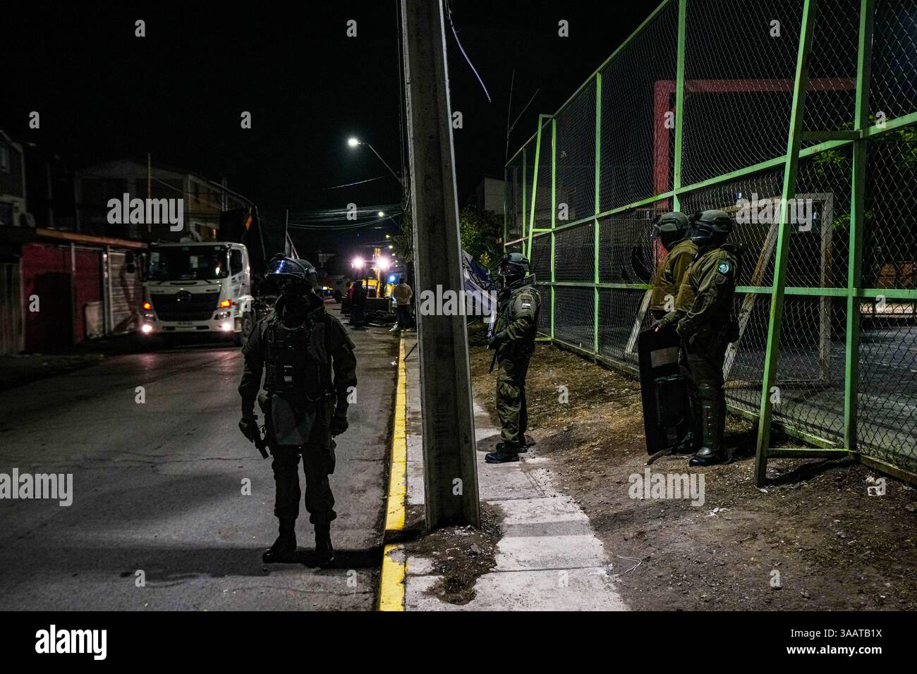 Police stand guard as workers dismantle a structure authorities allege ...