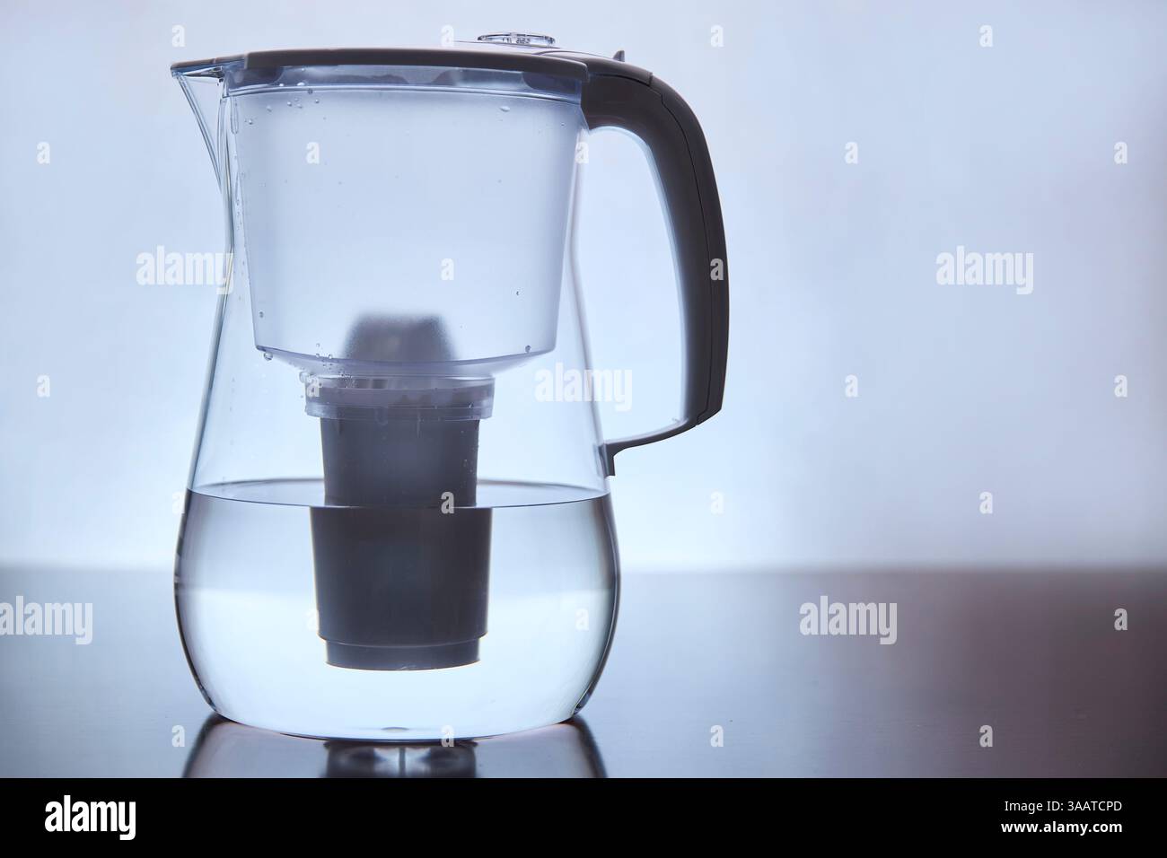 Transparent Water Filter Pitcher on Reflective Surface Stock Photo - Alamy
