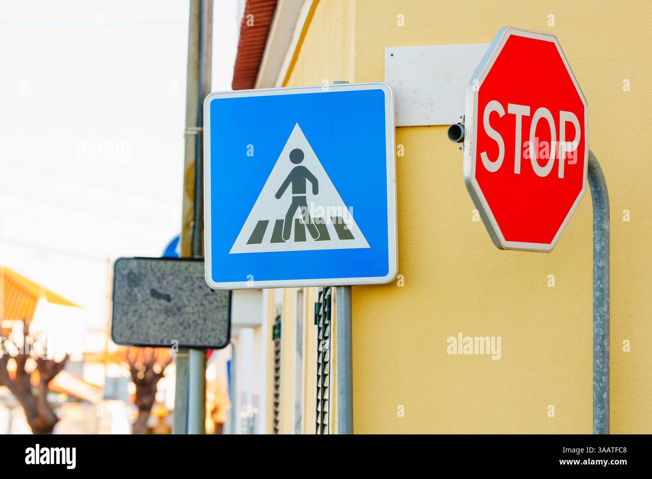 Road signs for pedestrians and stopping displayed on a street corner ...