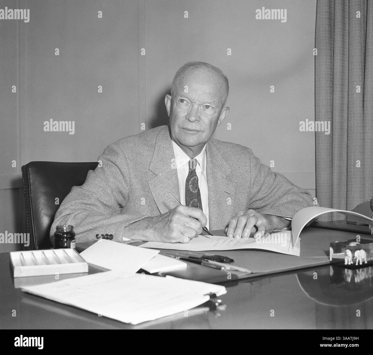 President Dwight D. Eisenhower looks up after signing the Civil Right's ...
