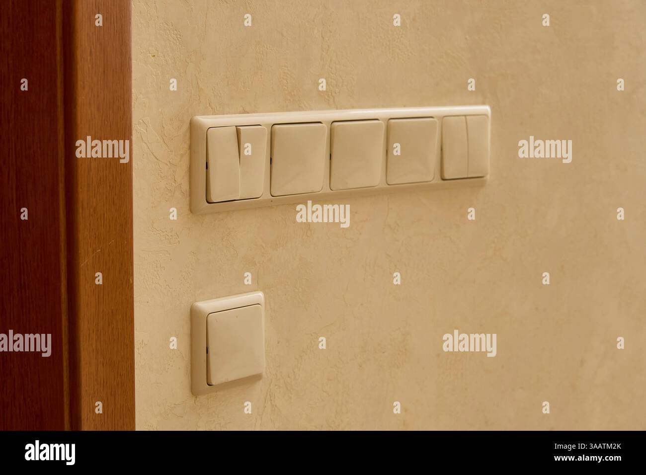 Image of a wall featuring seven light switches installed in a neat row ...