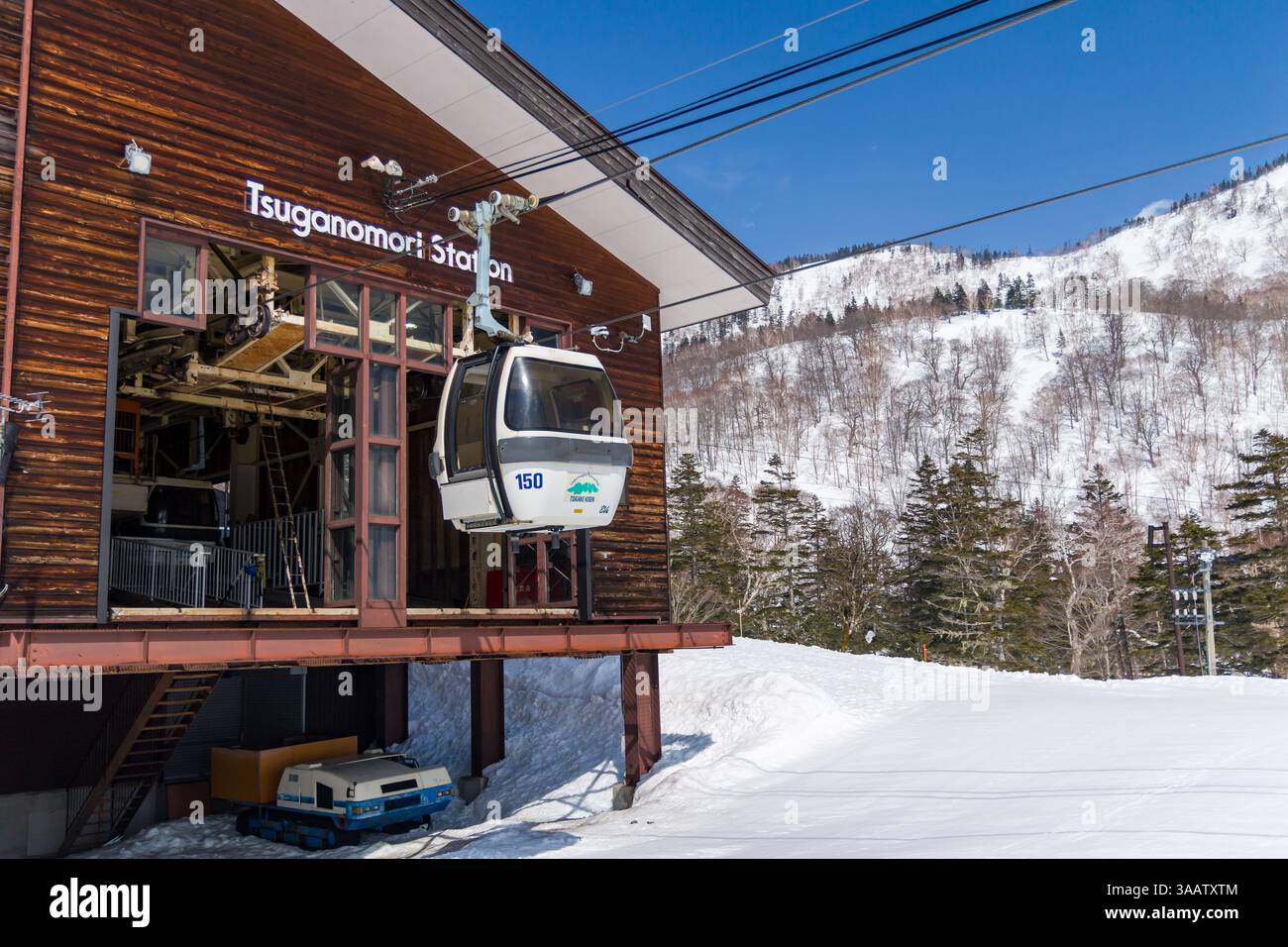Top gondola station with snow and background forest on sunny day at ...