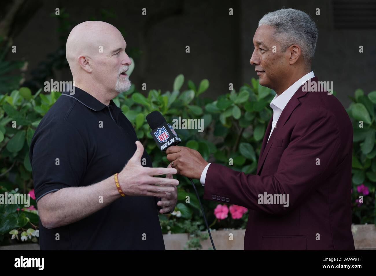 Washington Commanders head coach Dan Quinn, left, is interviewed by NFL ...